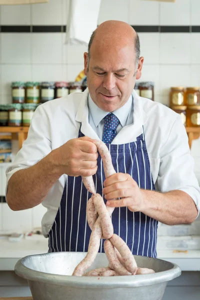 Male butcher linking sausages Pictures, Male butcher linking sausages ...
