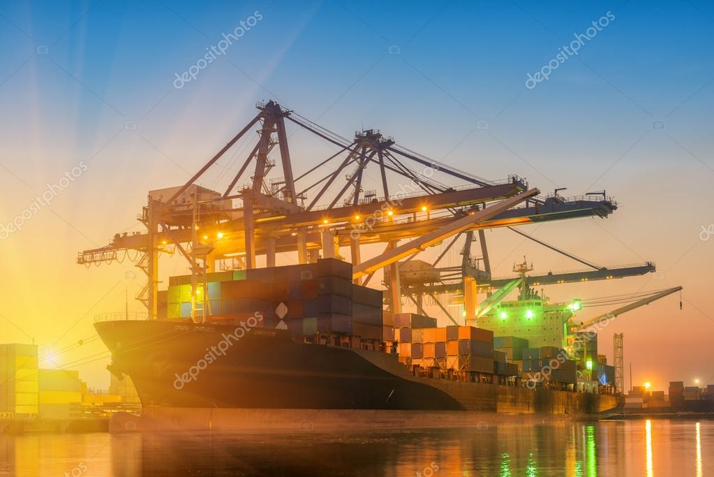 Unloading container of cargo ship terminal at twilight scene. — Stock ...
