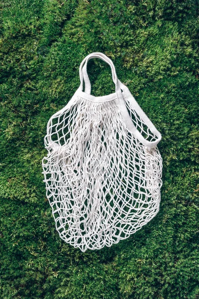 Reusable net bag or mesh shopper on green grass, moss background. Zero ...