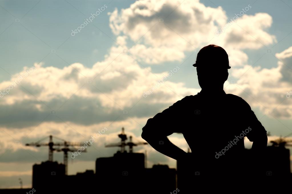 Dark silhouette of a builder — Stock Photo © SavelievDmytro #88333814