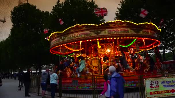 LONDON: Amusement park carousel with beautifully painted wooden horses ...