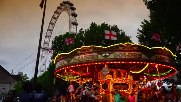 LONDON: Amusement park carousel with beautifully painted wooden horses ...