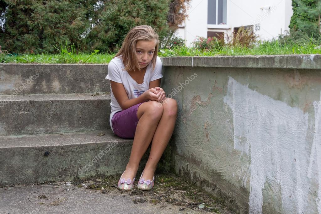 Sad child sits on stairs lonely — Stock Photo © Famiso #85492328