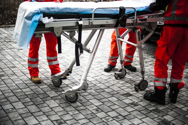 emergency volunteer operators with medical devices, stretcher and ...