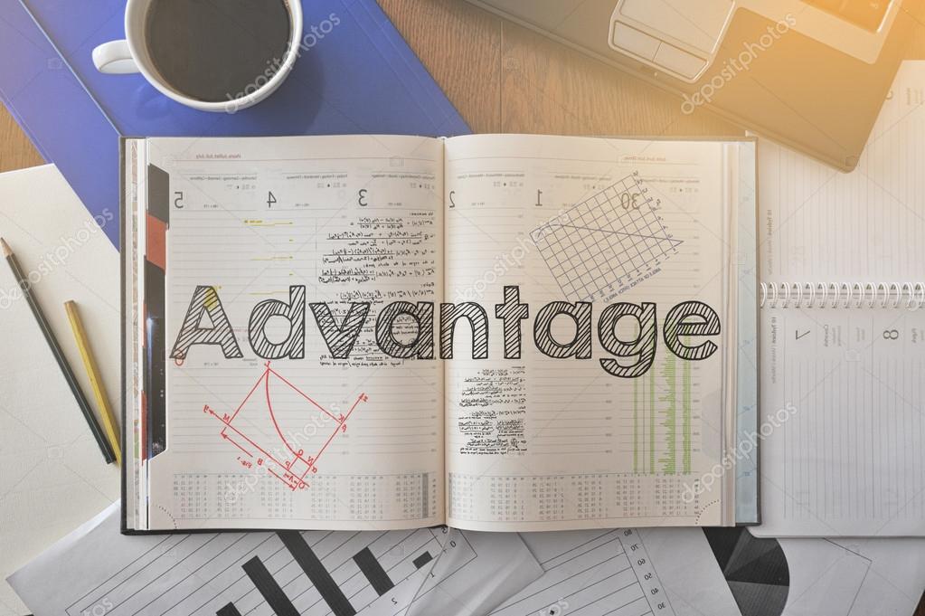 Notebook with text inside Advantage on table with coffee and some ...
