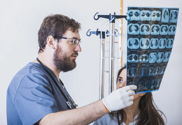 Two doctors emit X-ray photo of the patient to identify the problem ...