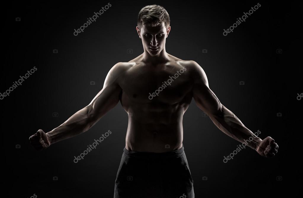 Strong man with his arms stretched out, looking at camera Stock Photo ...