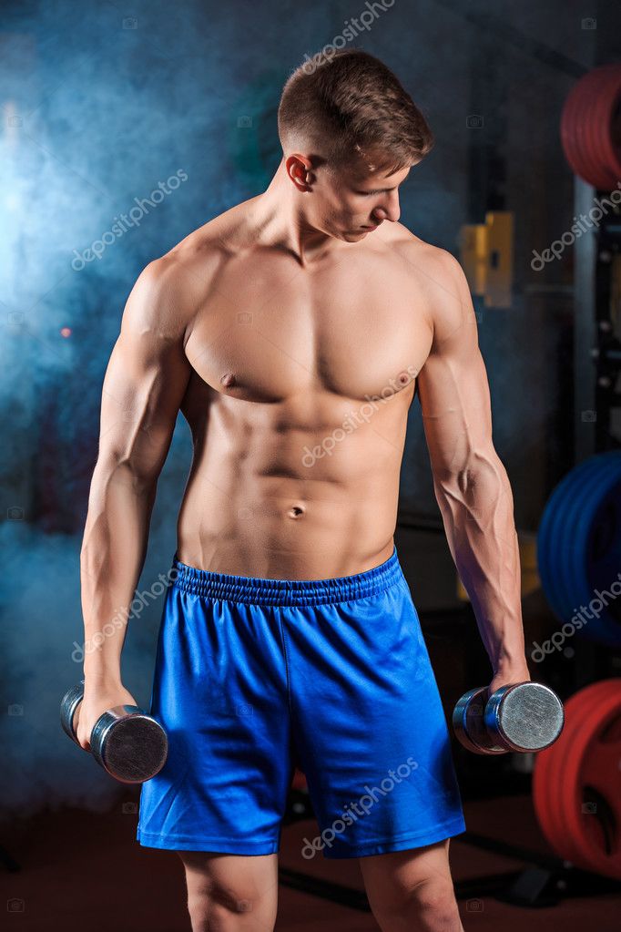 Man doing heavy weight exercise with dumbbells in gym Stock Photo by ...