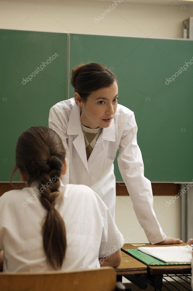Female teacher teaching a lesson Stock Photo by ©Focusarg 93813646