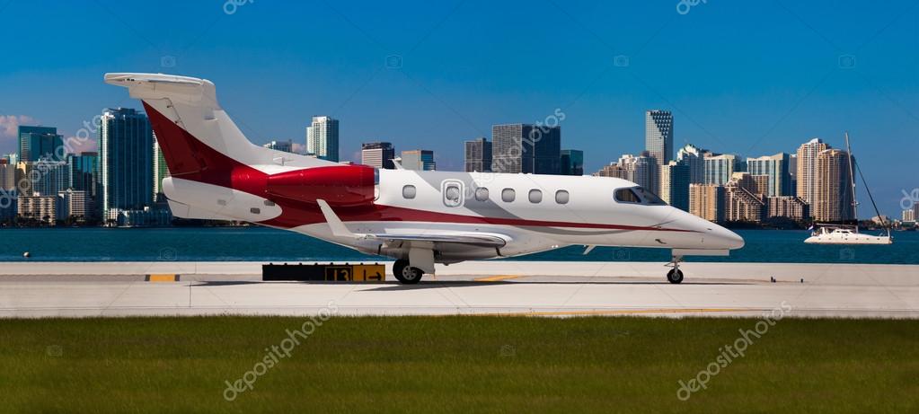 Private jet on the runway with city in the background Stock Photo by ...