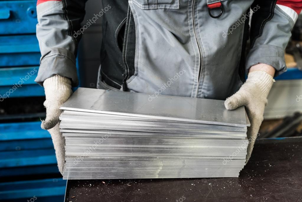 Small stack of steel plates on the bench miller, hand in working Stock ...