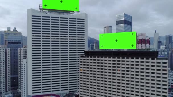 AERIAL. Top view of skyscrapers and green screen build board with ...