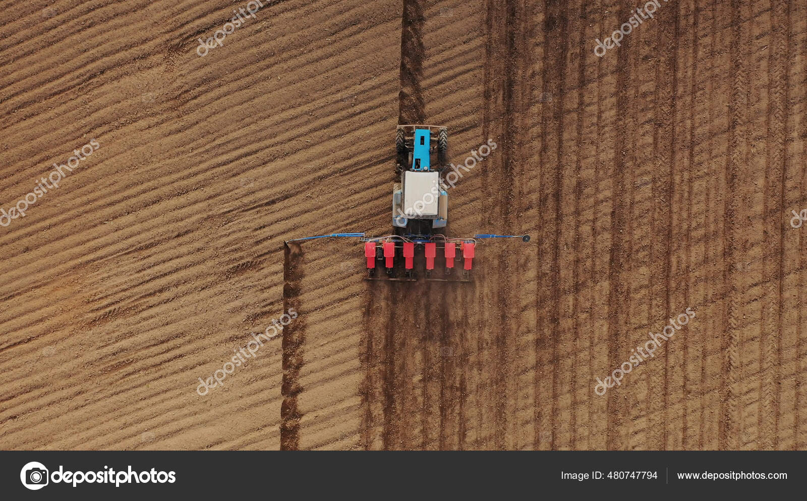 Aerial view of the tractor in the field, agricultural field work ...