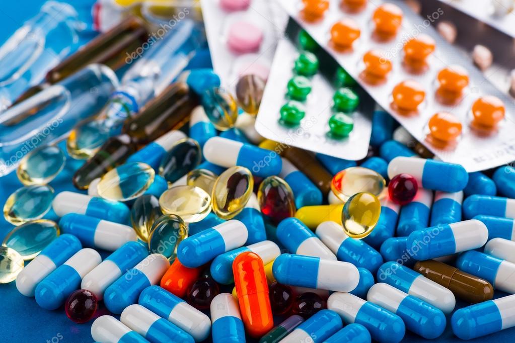 Medications tablets and capsules in a beaker — Stock Photo © bukhta79 ...