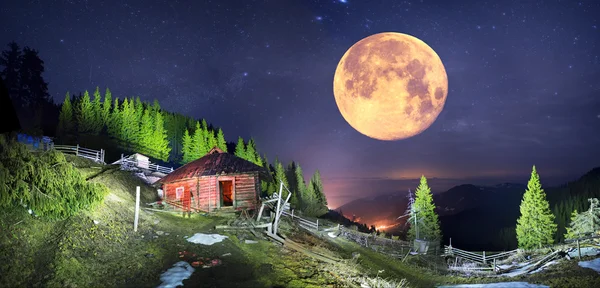 Old wooden hut at night - Stock Image - Everypixel