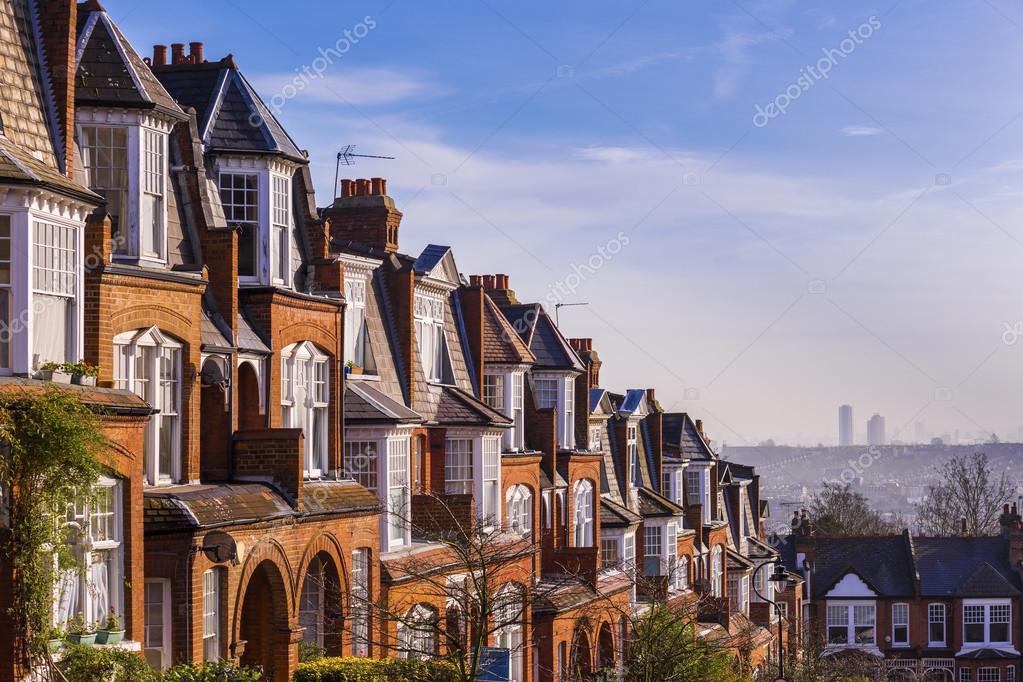Traditional British brick houses on a cloudy morning with east London ...