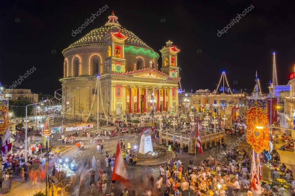 MOSTA, MALTA - 15 AUG. 2016: Mosta festival at night with the famous Mosta Dome at it's full ...