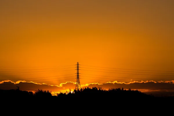 Sunset against electric post. - Stock Image - Everypixel