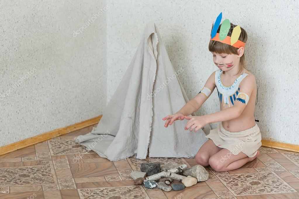 Blond boy playing injun Stock Photo by ©familylifestyle 109774188
