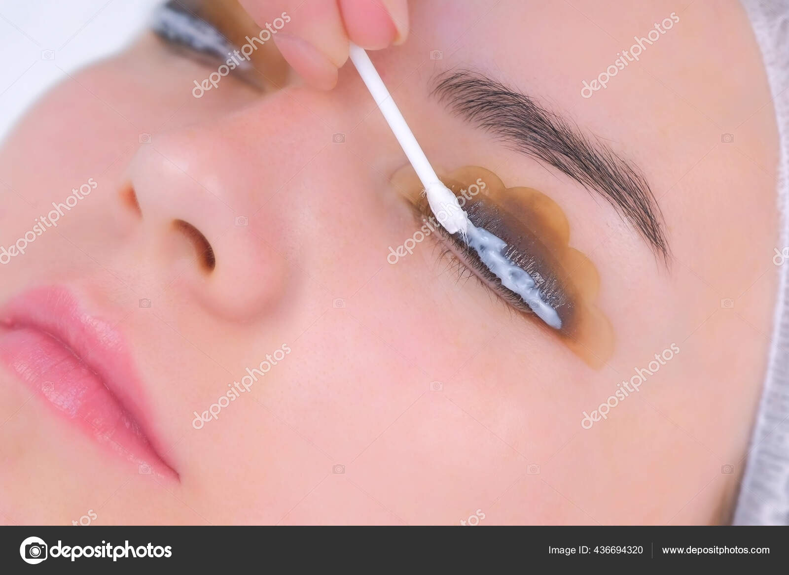Beautician applying solution for lamination on lashes, lift eyelashes ...