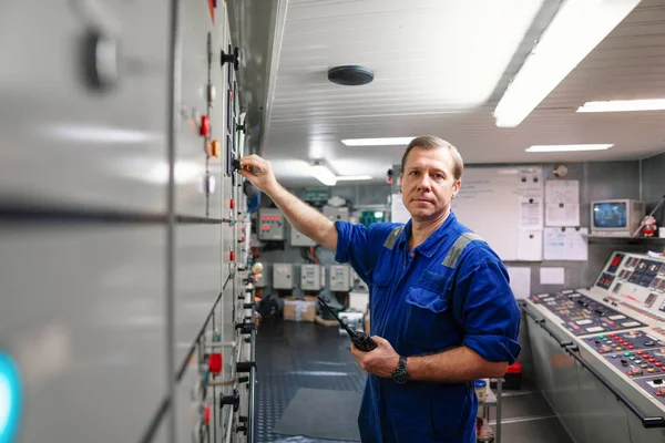 Marine engineer officer controlling vessel engines and propulsion in ...
