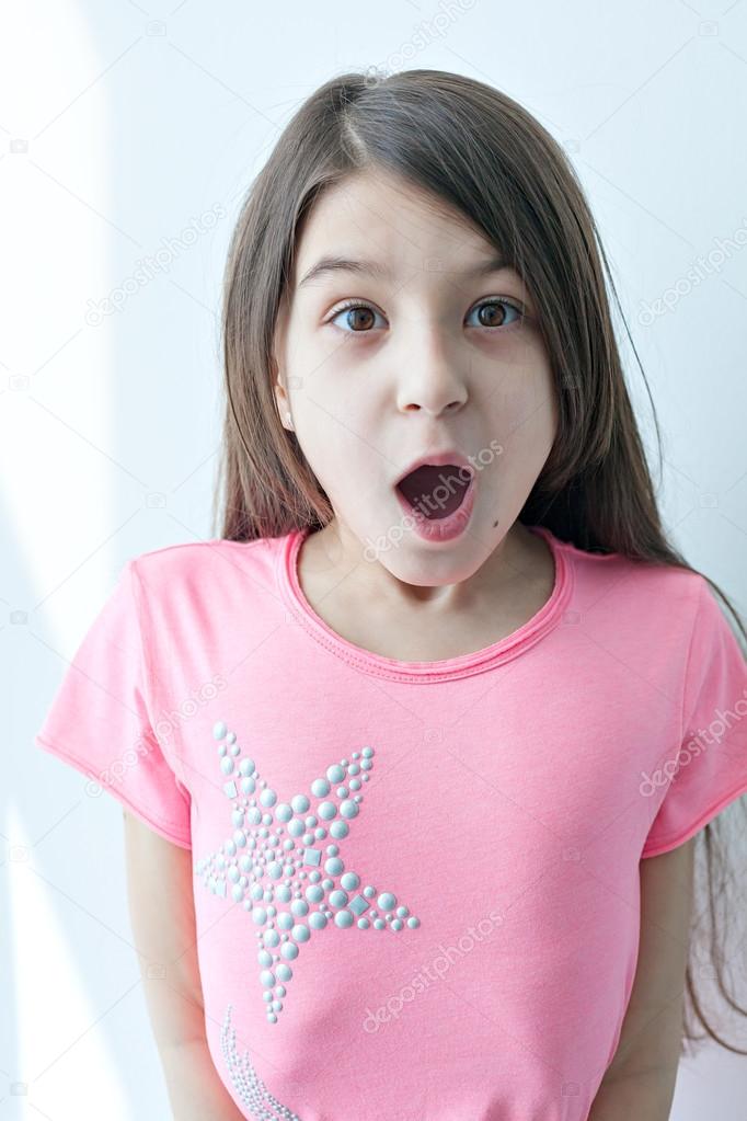 Little girl making a funny face. — Stock Photo © Mukhomedianova #105874878