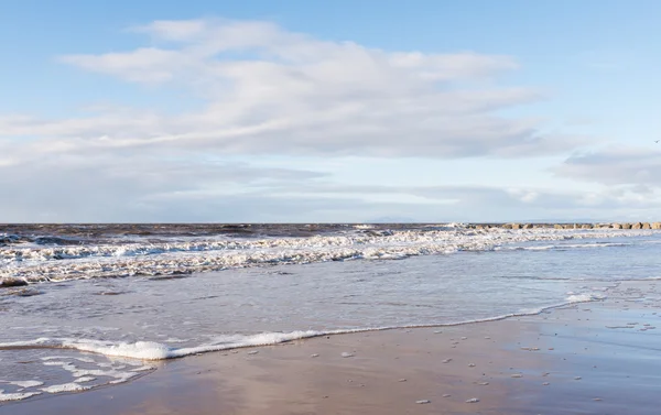 Relaxing and gentle calming waves flowing into a beach at sundown ...