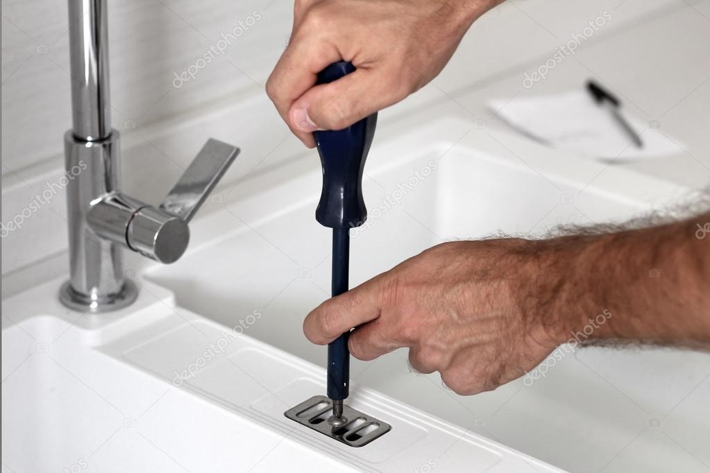 Repairman fixing a kitchen sink Stock Photo by ©tostphoto 109191562