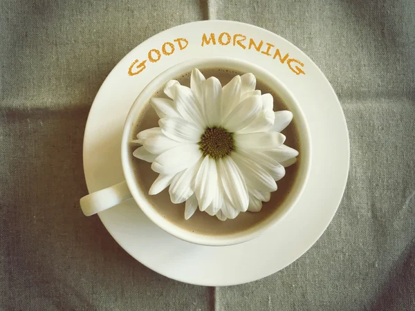 Coffee cup on table with white daisy and words Hello Thursday vi Stock ...