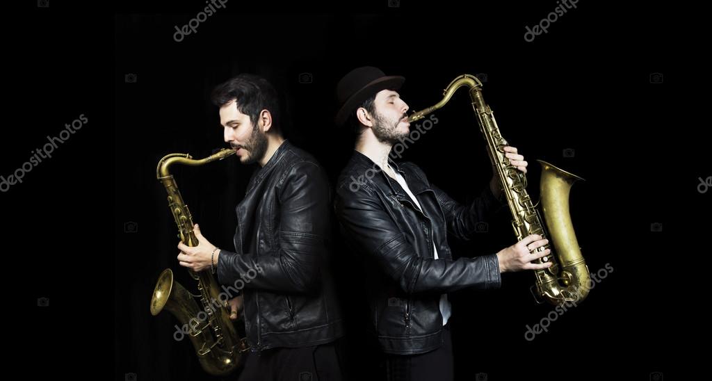A saxophone players dark background. Saxophonist jazz man wit Stock ...