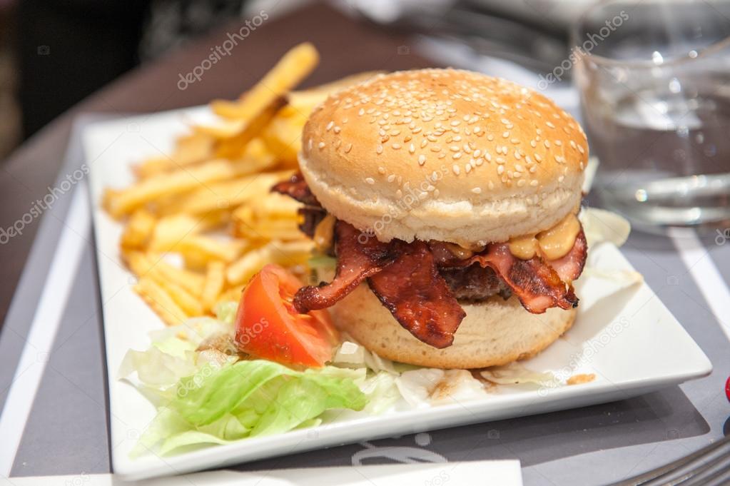 Close up of a bacon cheese burger and fries on a plate — Stock Photo ...