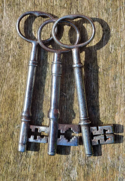 Three Antique Keys on rustic wood - Stock Image - Everypixel
