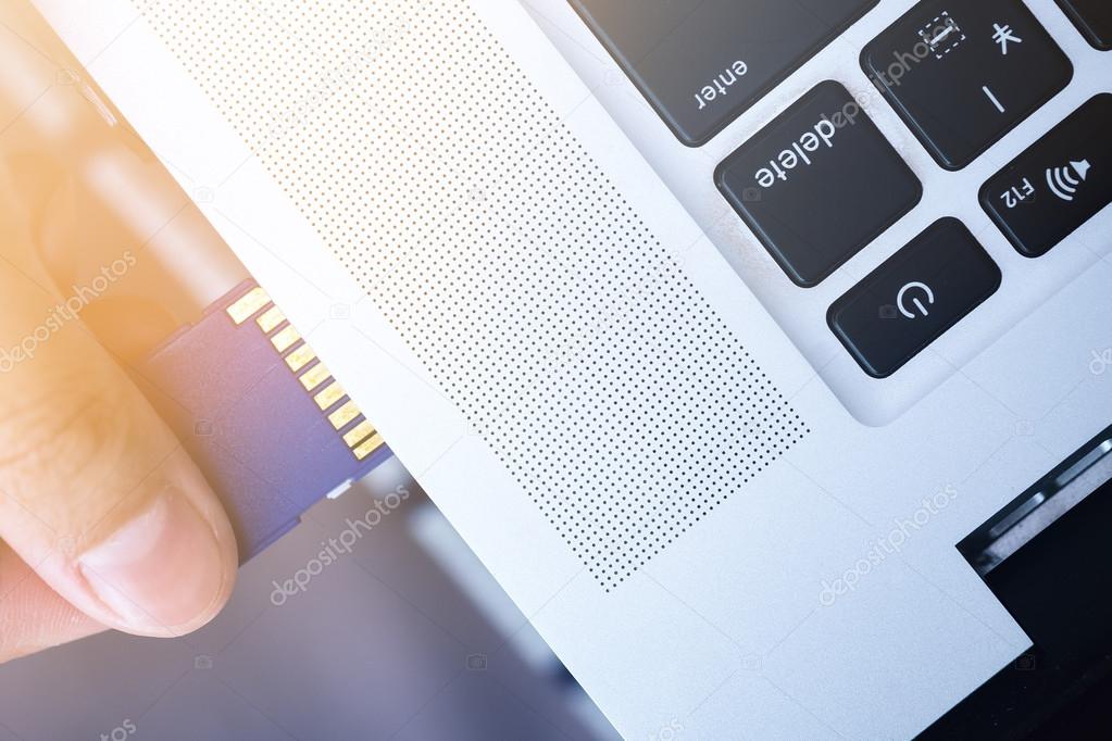 Plugging in SD Card into personal computer ready for photo file ...