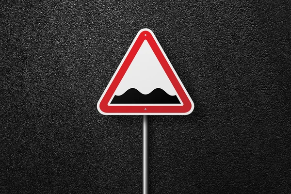 Road signs of the triangular shape on a background of asphalt. The ...