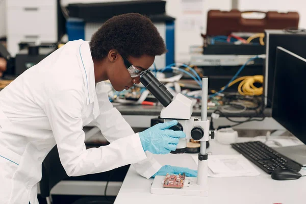 Scientist african american woman working in laboratory with electronic ...