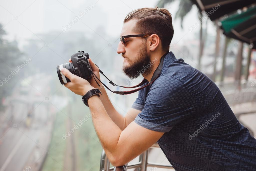 Happy young guy with big camera — Stock Photo © sergey_causelove #96926672