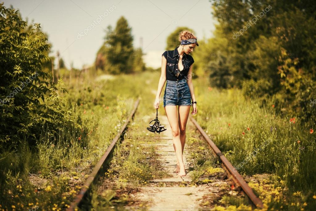 Girl posing on rails Stock Photo by ©sergey_causelove 98331002