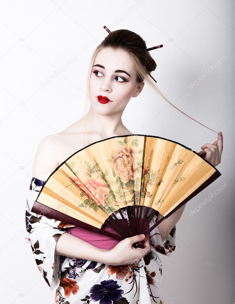 Beautiful Girl Dressed As A Geisha She Holds A Chinese Fan Geisha