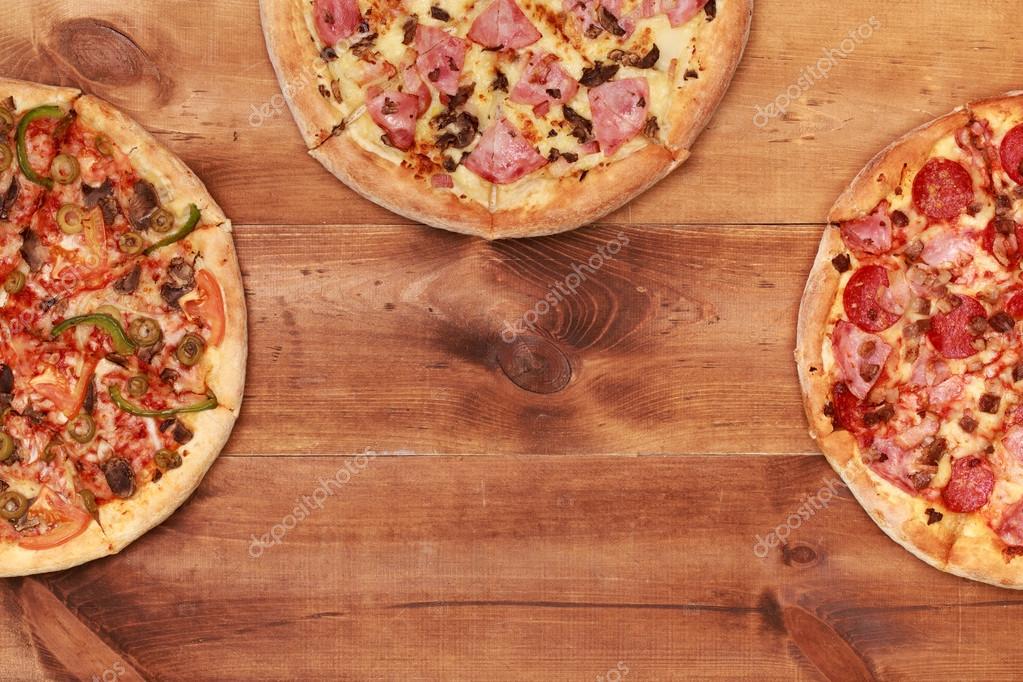 Three tasty pizzas on table — Stock Photo © andrei.dvaretski.yandex.ru ...