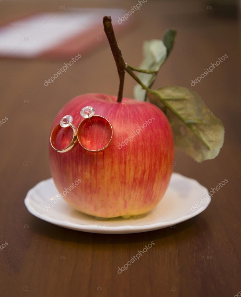 Wedding rings on a red Apple — Stock Photo © Sanchos303 #100933064