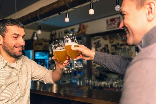 Colleagues drinking beer after work Stock Photo by ©microgen 115107848