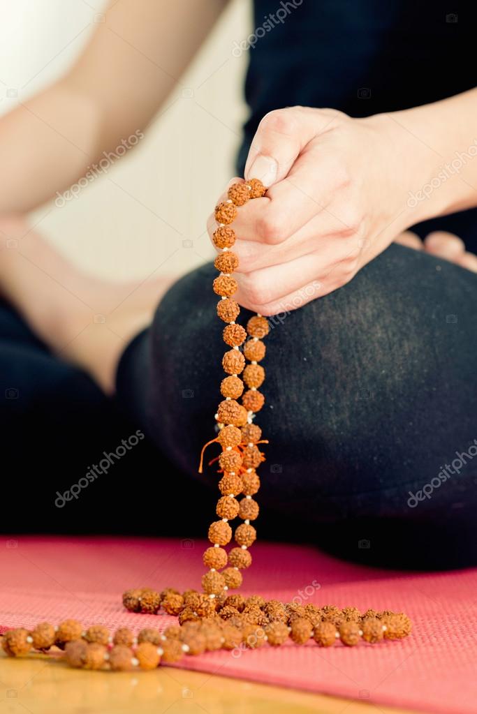 Hands with rudraksha beads Stock Photo by ©microgen 115158850