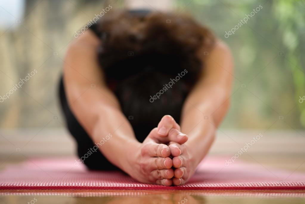 Woman doing Half Tortoise Position Stock Photo by ©microgen 115158994