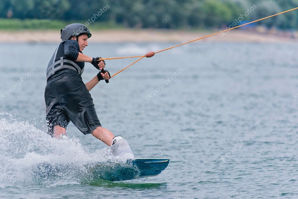 Female wakeboarder performing stunt — Stock Photo © microgen #115159058