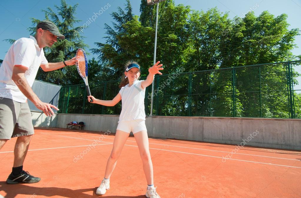 Tennis instructor with Junior player Stock Photo by ©microgen 115174556