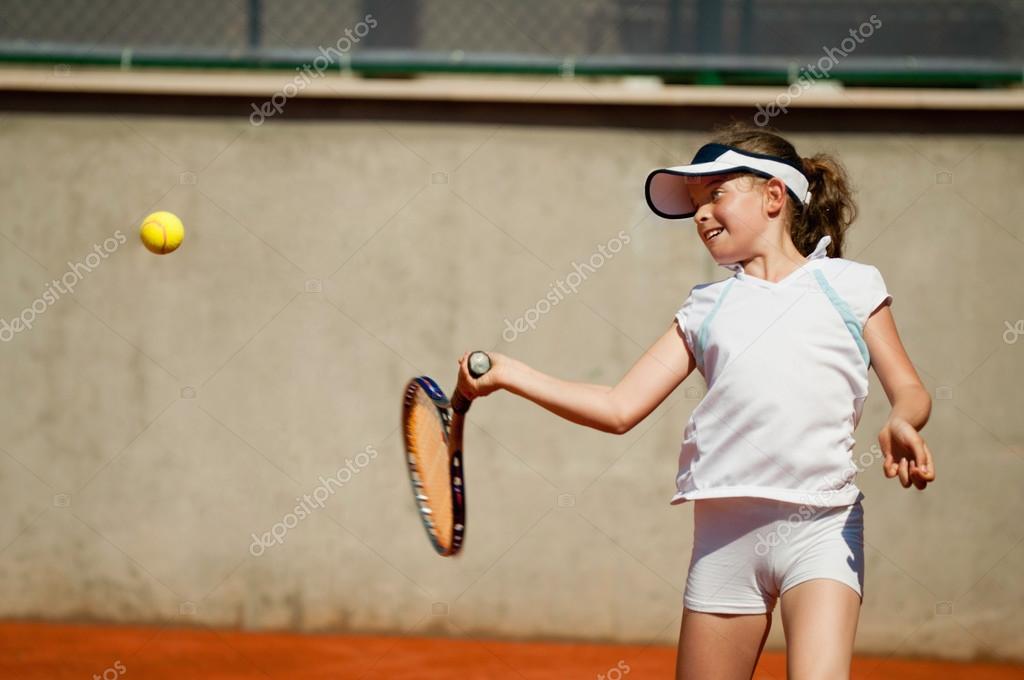 Young girl practicing forehand — Stock Photo © microgen #115179018