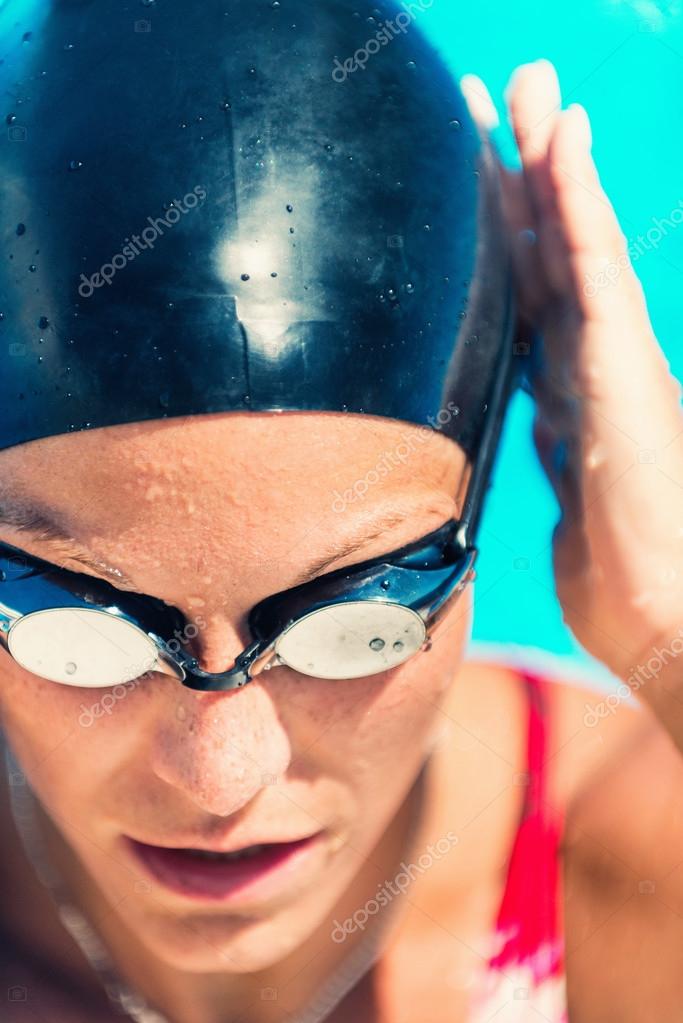 Female swimmer face Stock Photo by ©microgen 115179336