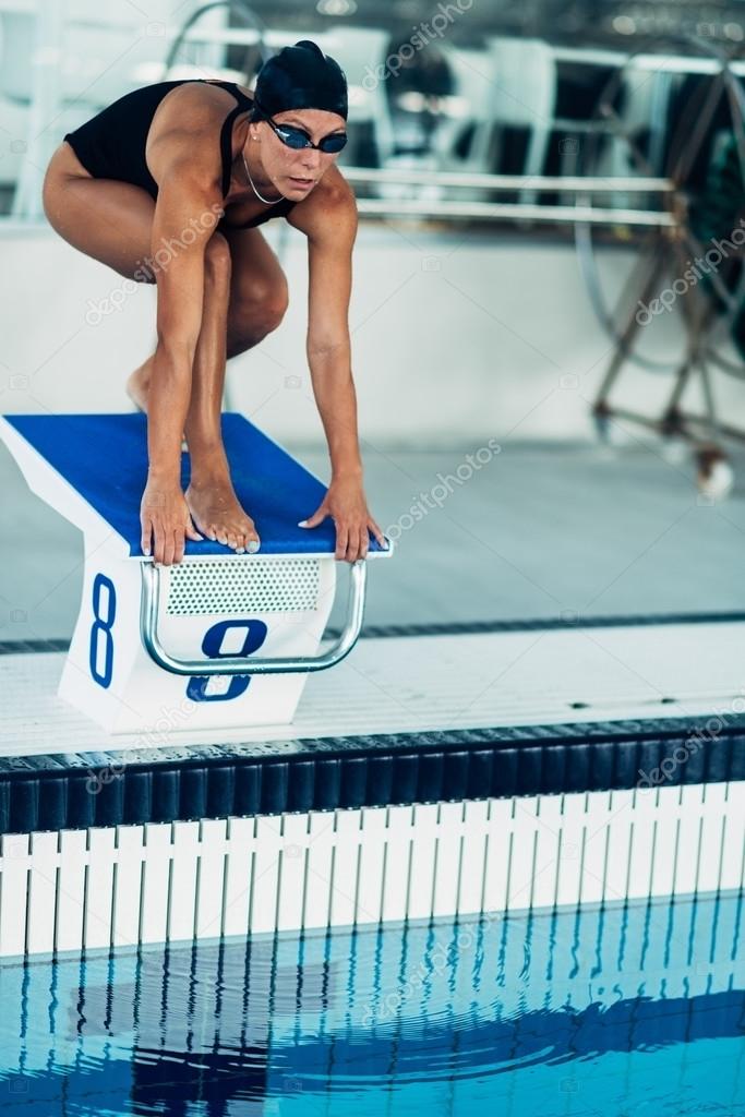 Female swimmer on start position — Stock Photo © microgen #115181280