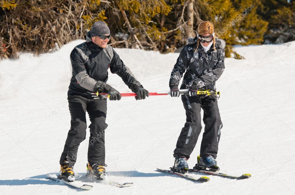 Instructor teaching woman to ski Stock Photo by ©microgen 115192700