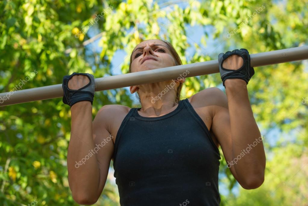 Female doing pull ups — Stock Photo © microgen #115217166